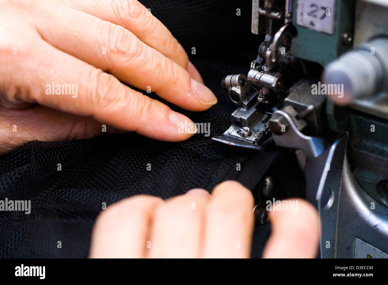 Hands work a sewing machine Stock Photo - Alamy