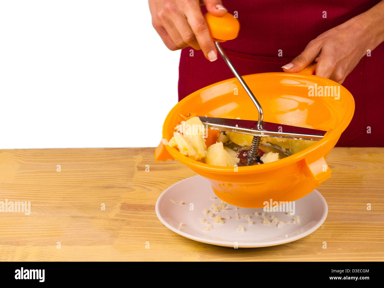 Using a food mill to prepare mashed potatoes Stock Photo - Alamy
