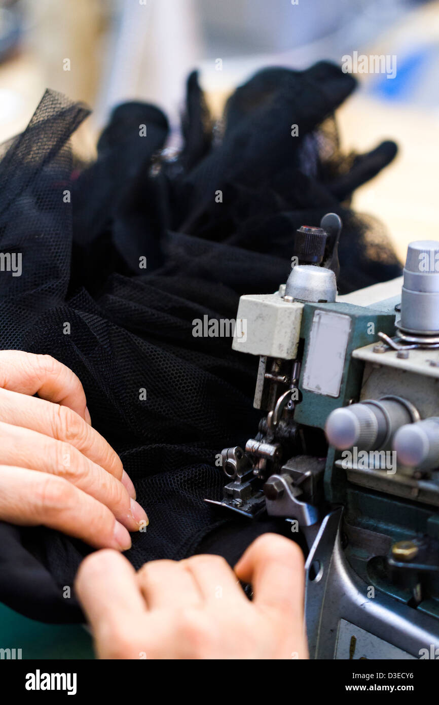 Hands work a sewing machine Stock Photo - Alamy