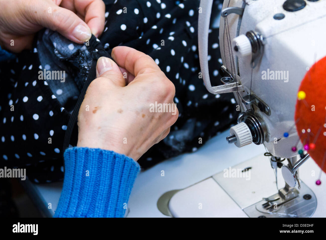 Hands work a sewing machine Stock Photo - Alamy