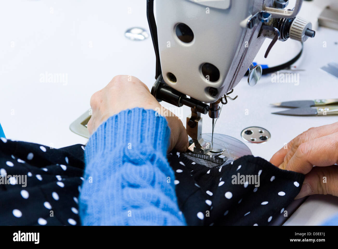 Hands work a sewing machine Stock Photo - Alamy