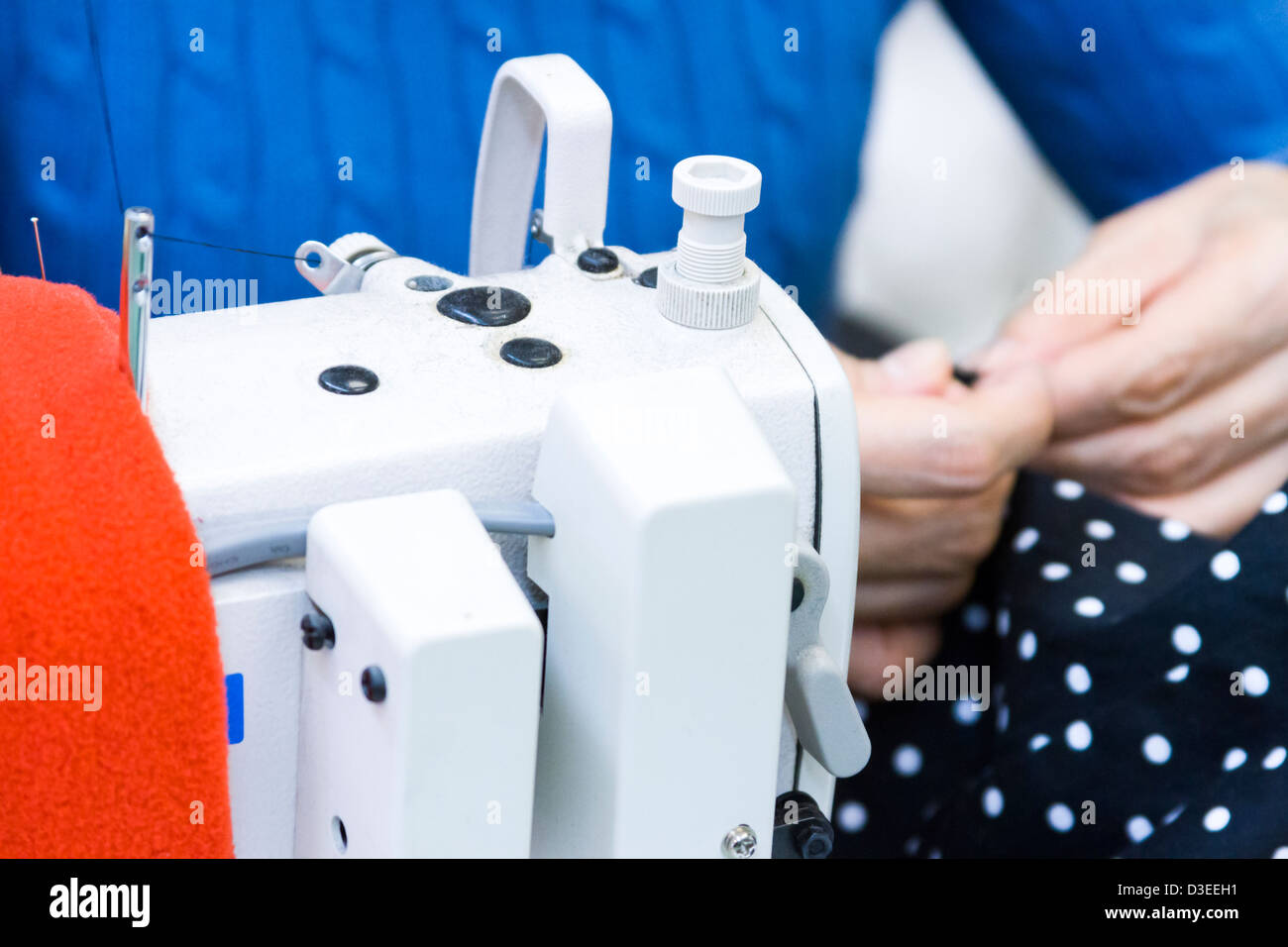 Hands work a sewing machine Stock Photo - Alamy