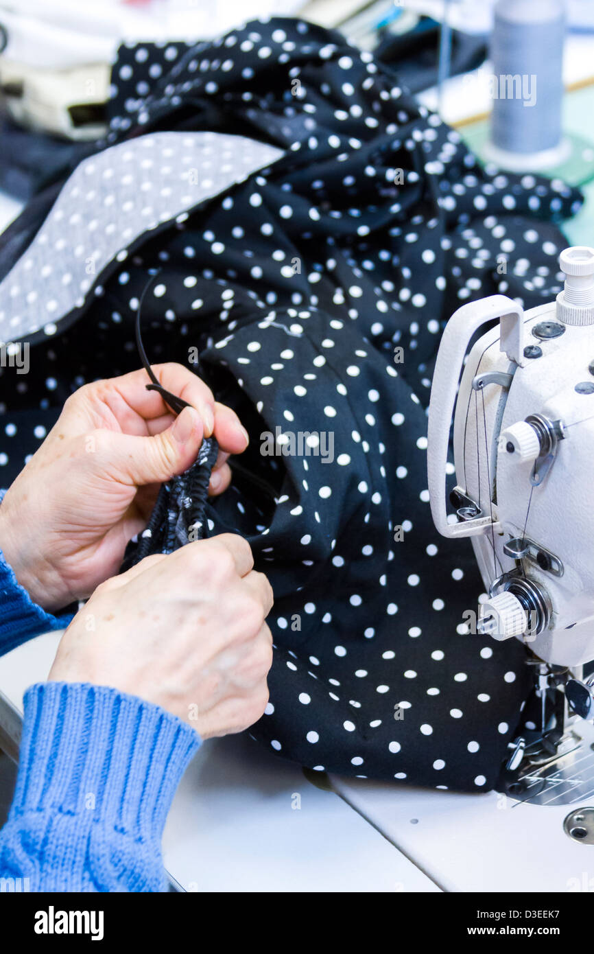 Hands work a sewing machine Stock Photo - Alamy