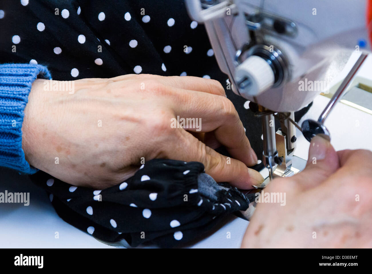 Hands work a sewing machine Stock Photo - Alamy