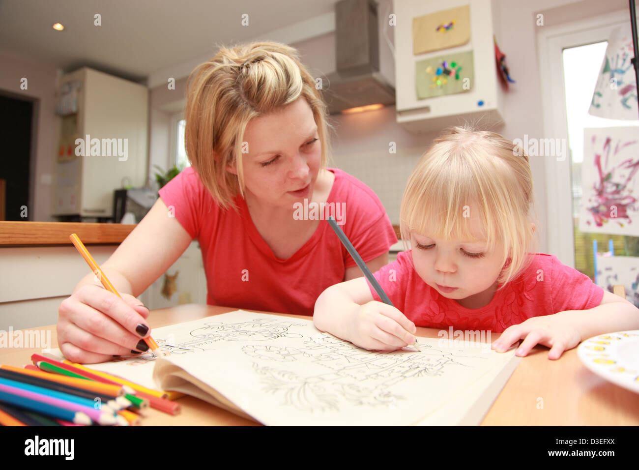 Mother and daughter coloring together Stock Photo - Alamy