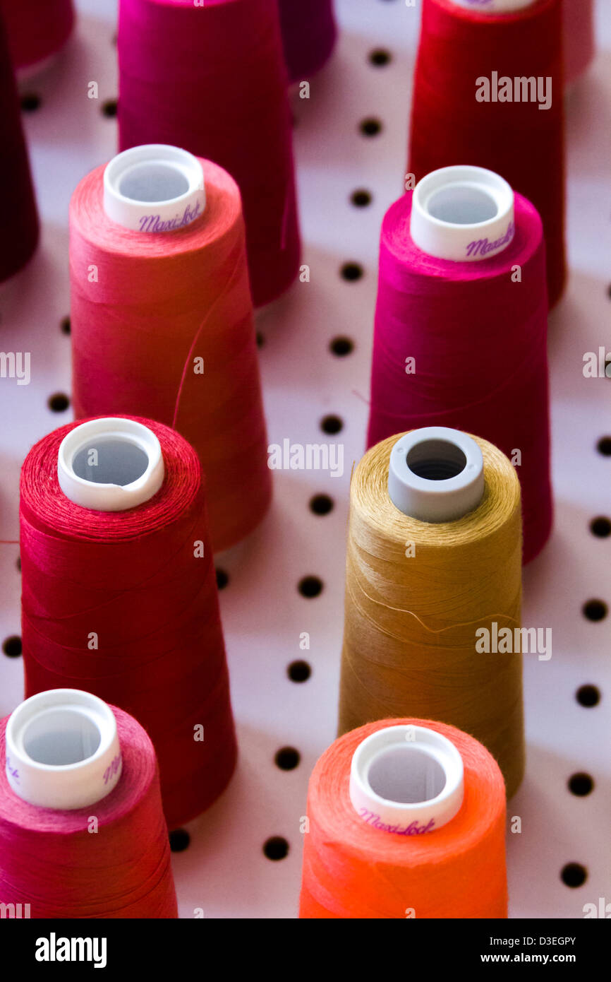 Colorful spools of thread on the wall in tailor shop Stock Photo - Alamy