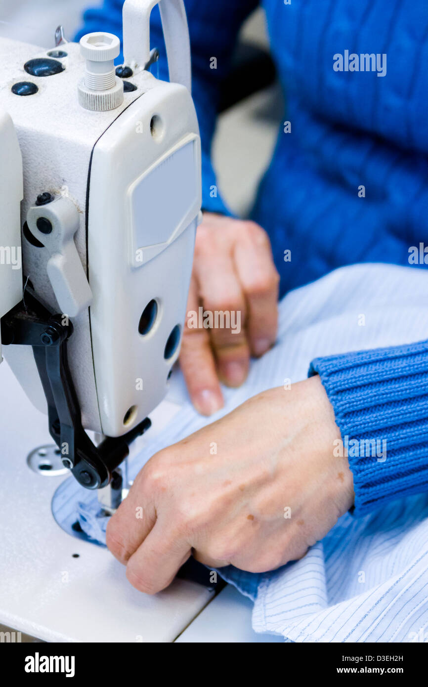 Hands work a sewing machine Stock Photo - Alamy