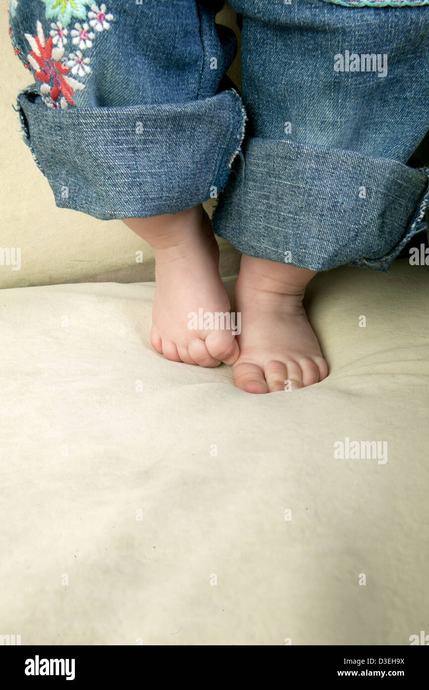 Baby feet in beige background Stock Photo - Alamy