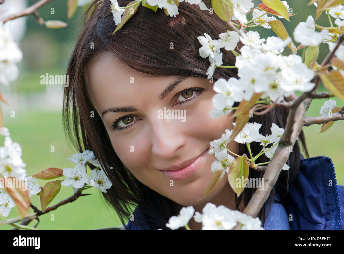 Beautiful woman under blooming tree in spring Stock Photo - Alamy