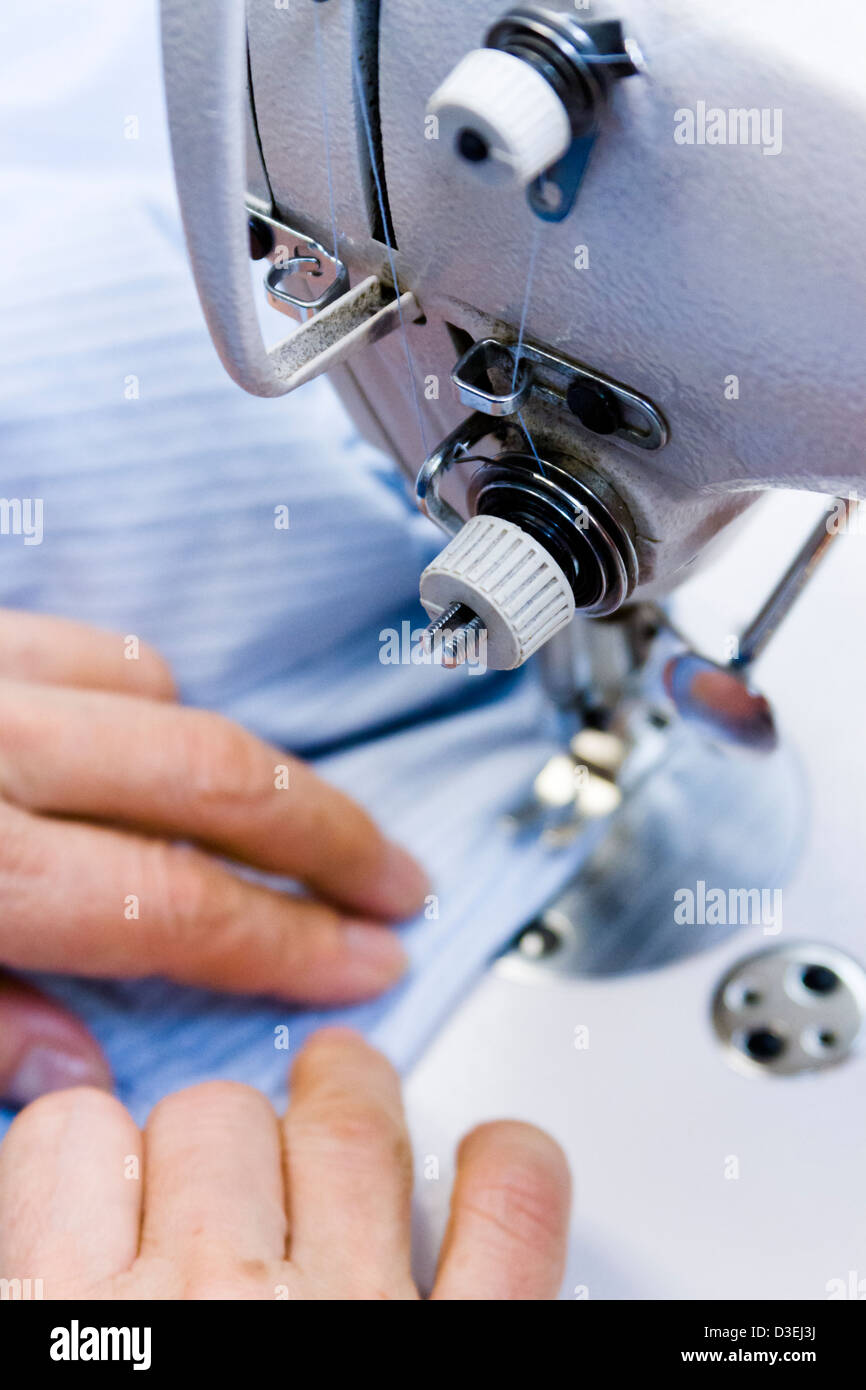 Hands work a sewing machine Stock Photo - Alamy