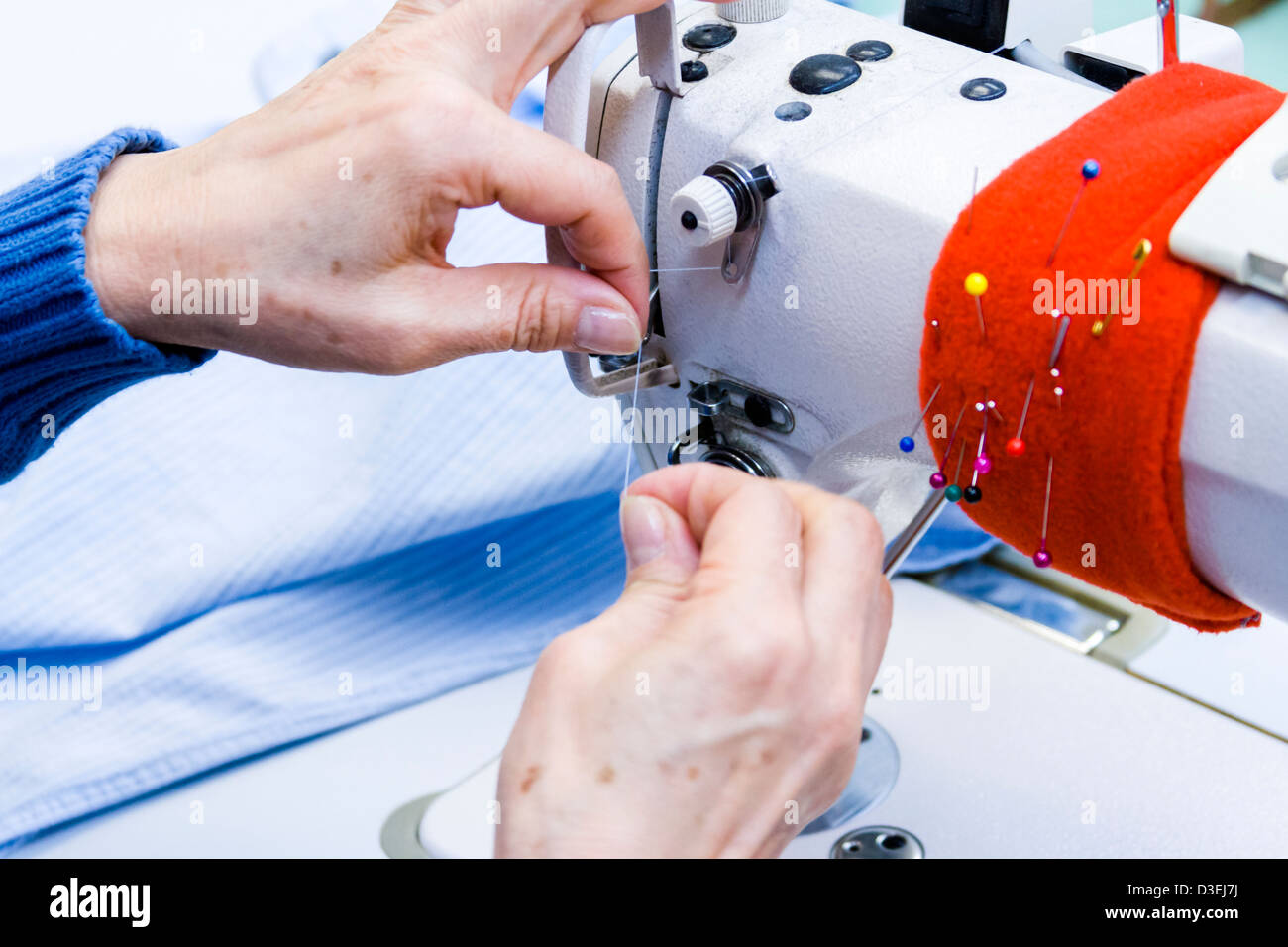 Hands work a sewing machine Stock Photo - Alamy