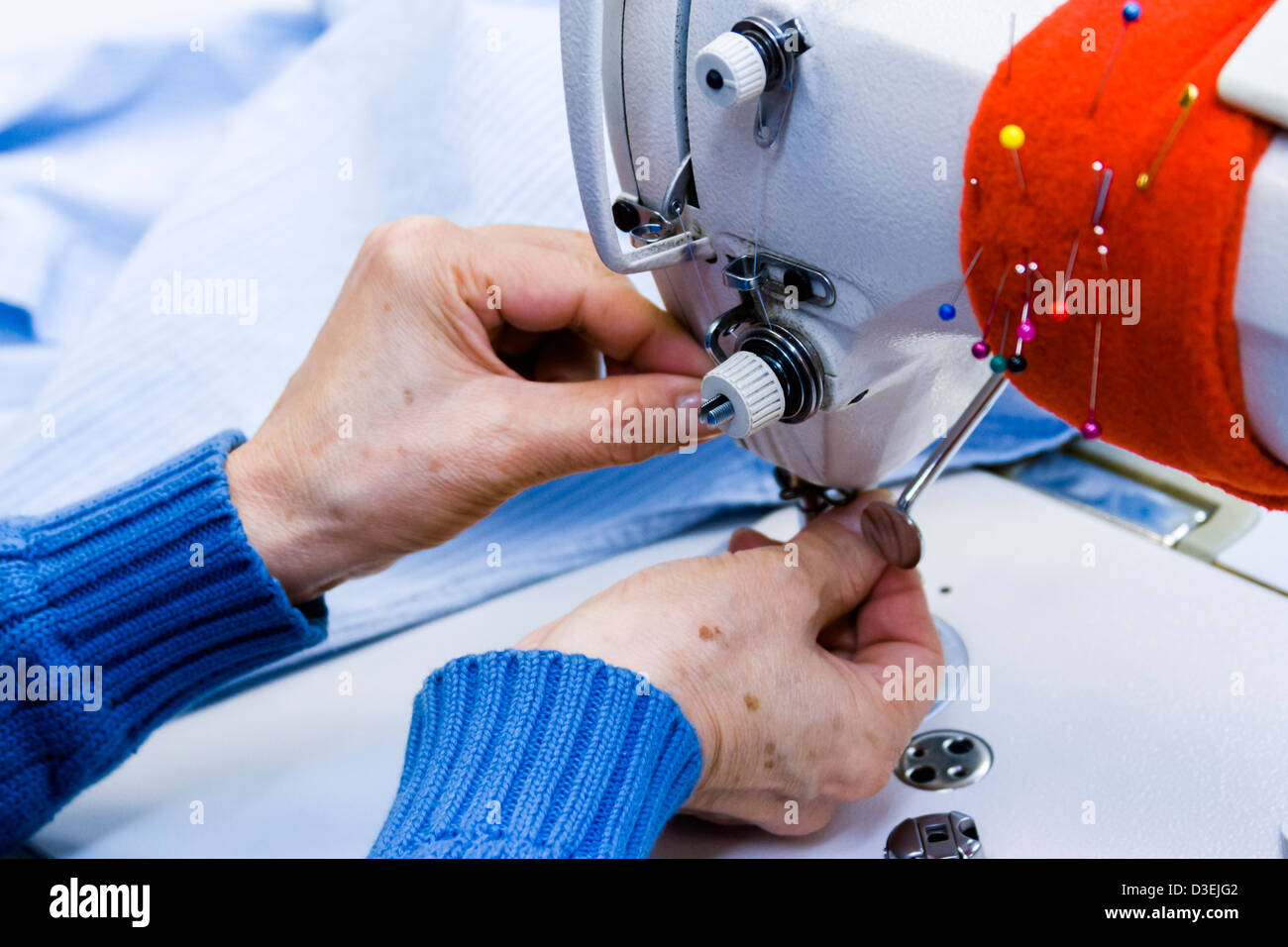 Hands work a sewing machine Stock Photo - Alamy