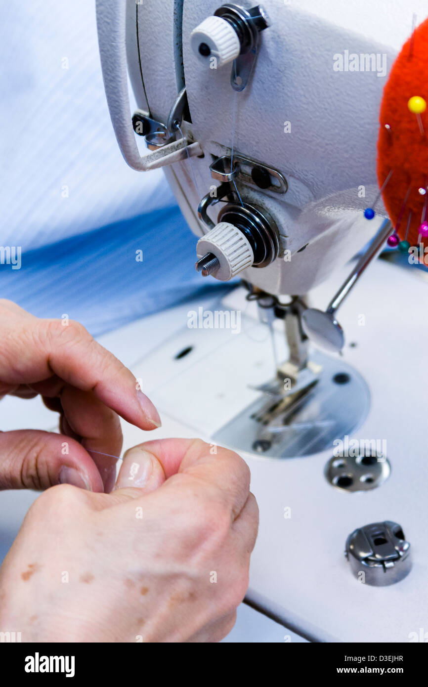 Hands work a sewing machine Stock Photo - Alamy