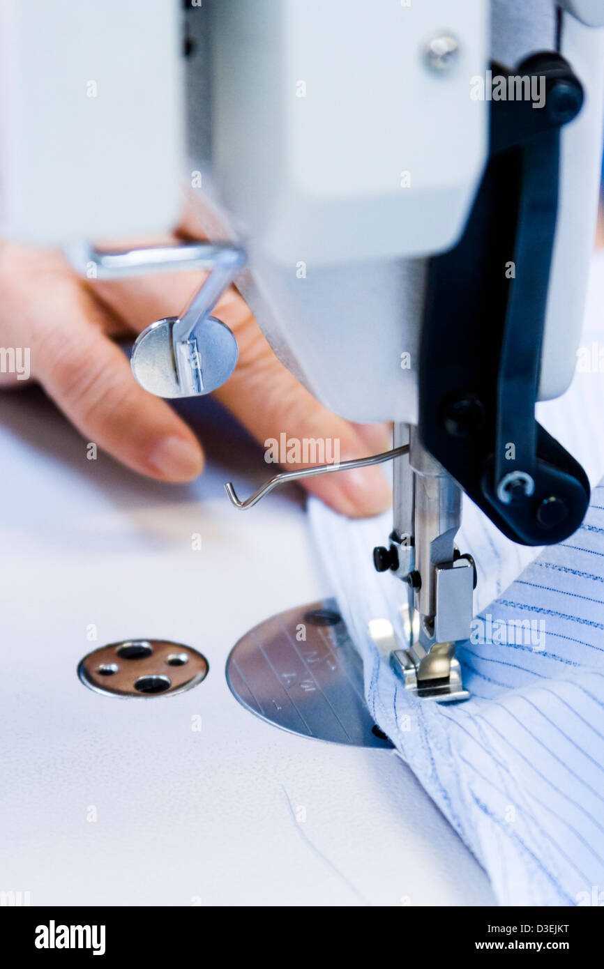 Hands work a sewing machine Stock Photo - Alamy
