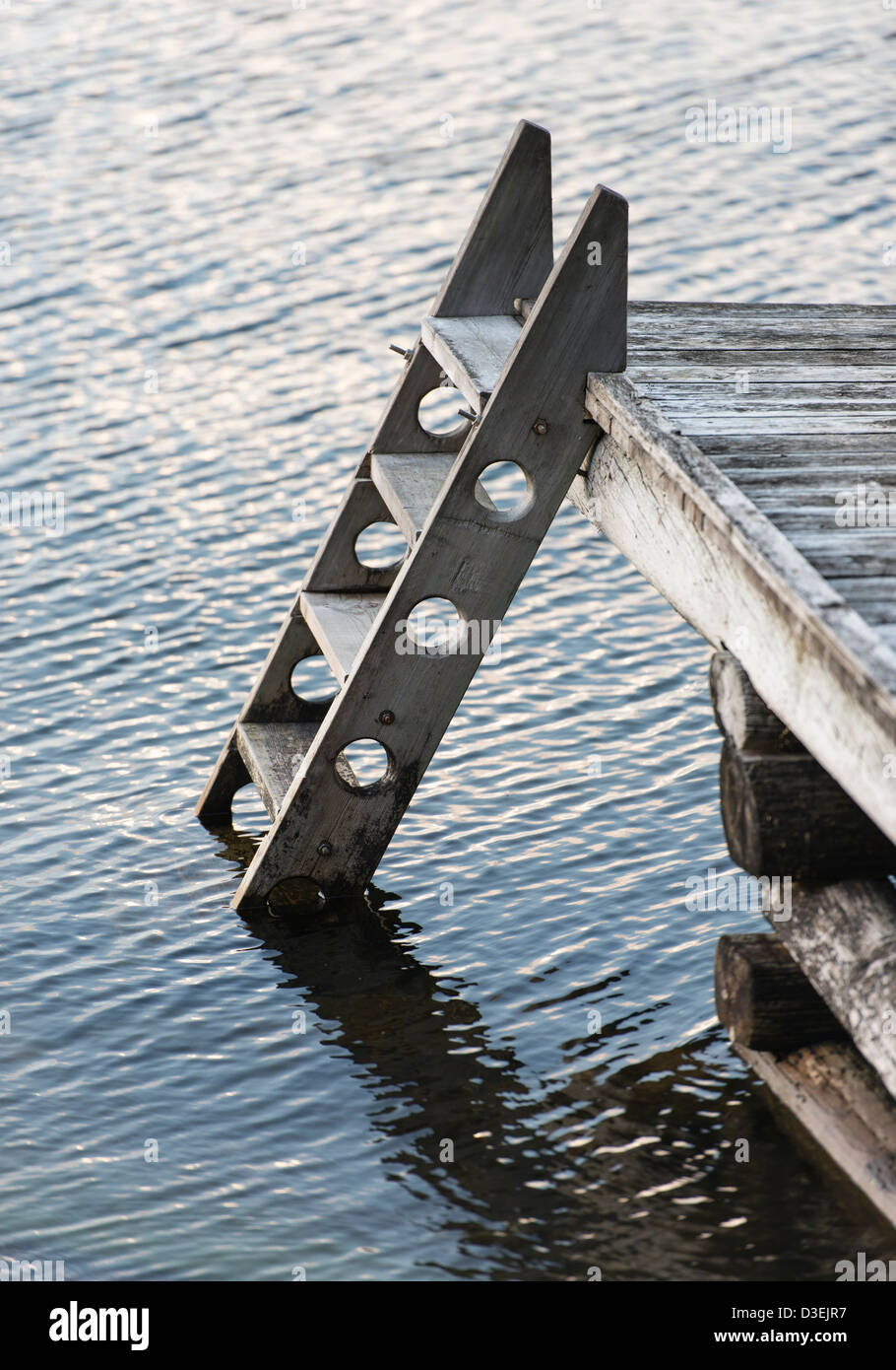 Tranquil evening scene of the sea and wooden jetty with step ladder in ...
