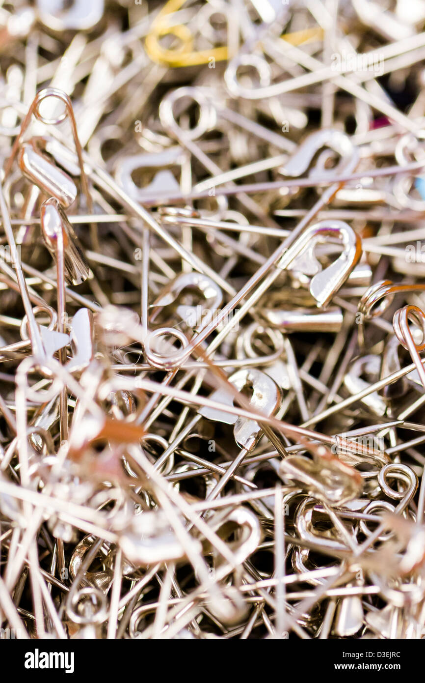 Silver safety pins in a pile Stock Photo - Alamy
