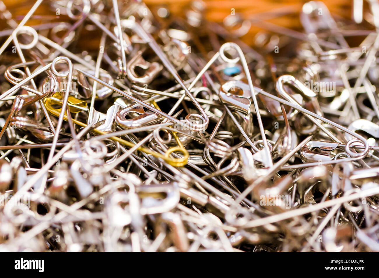 Silver safety pins in a pile Stock Photo - Alamy