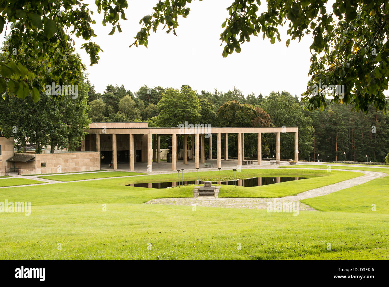 Chapel of the holy cross, lawn and pond at skogskyrkogarden cemetery in ...