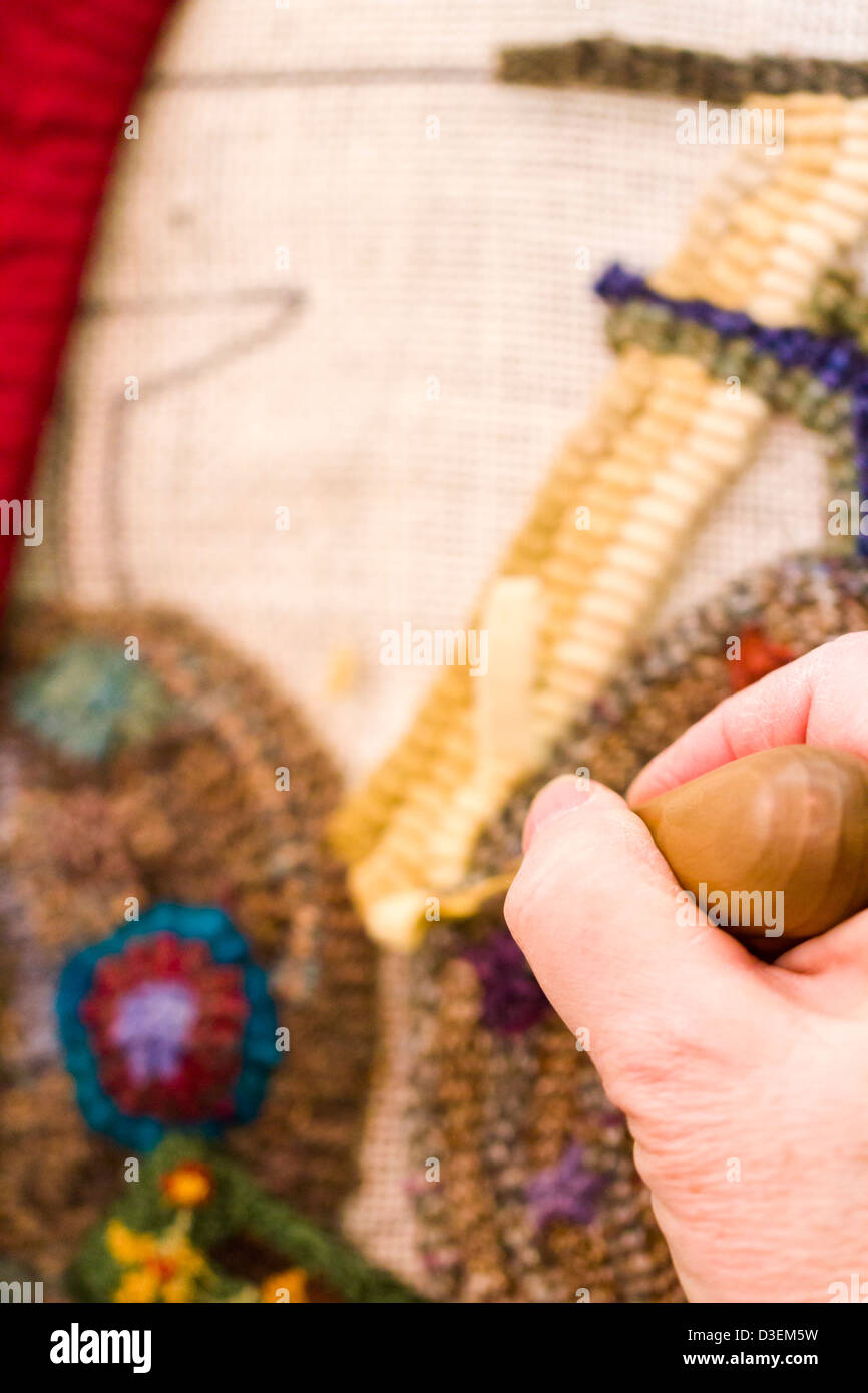 Hands work a hook in hug hooking craft Stock Photo - Alamy