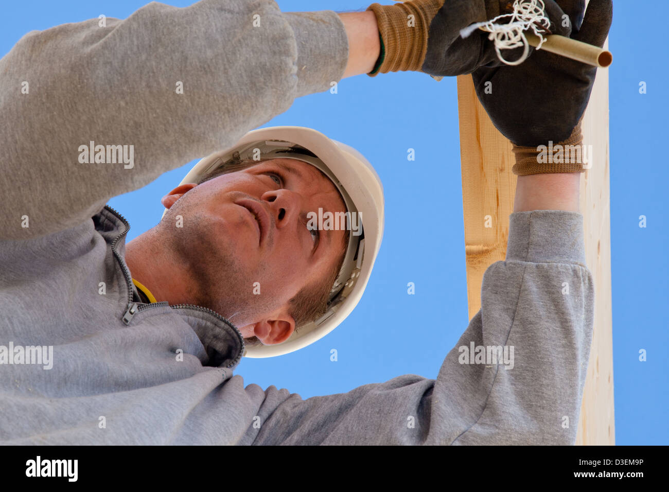 real builder at work with roof construction on building site Stock ...
