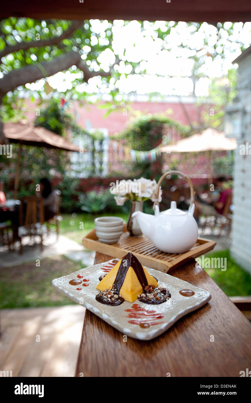 Peru, Lima, Barranco. In the garden of cafeteria Bodega Verde. Teapot ...