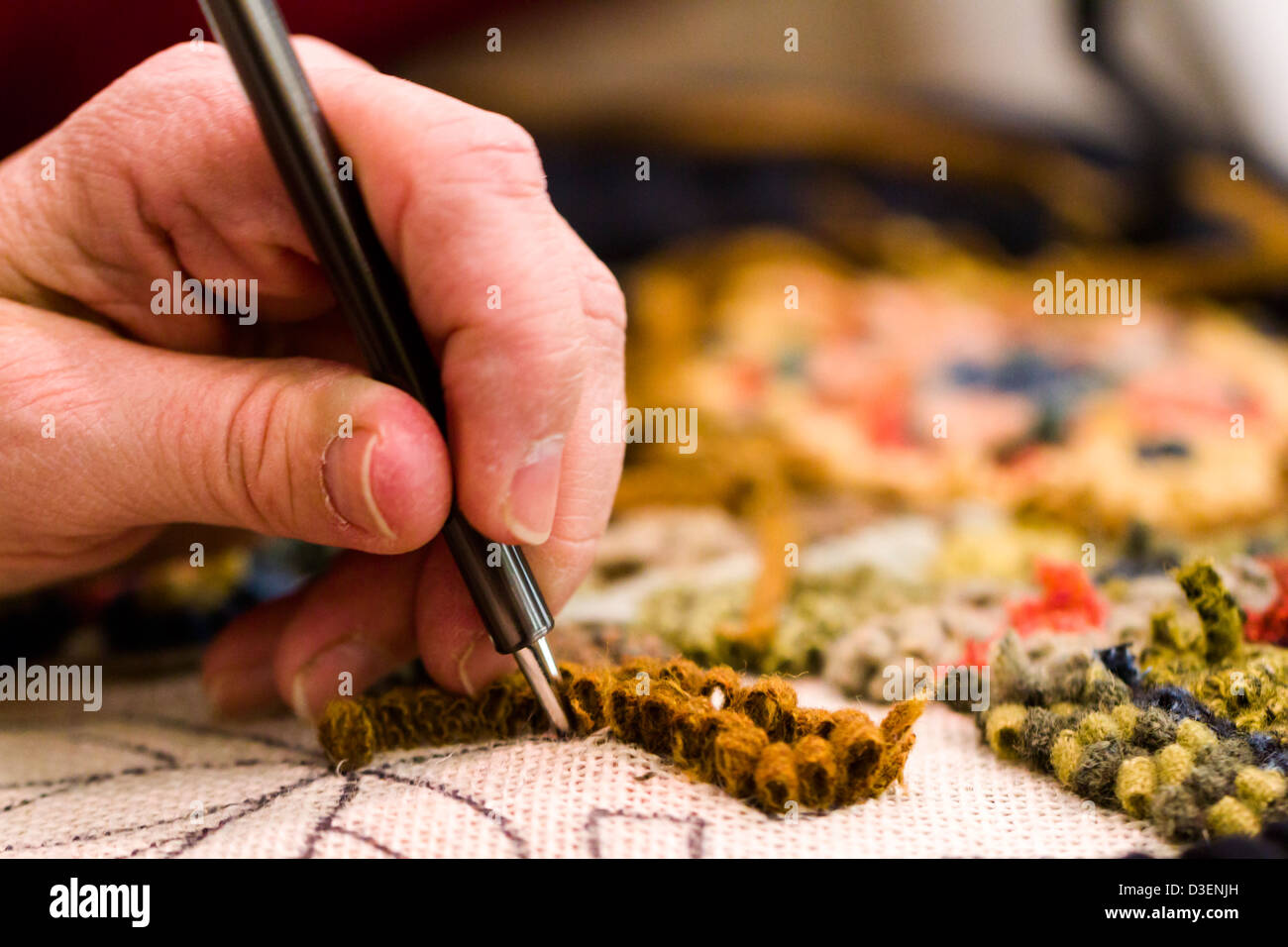 Hands work a hook in hug hooking craft Stock Photo - Alamy