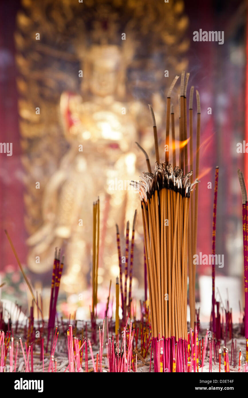 Incense bars burning in front a buddha. Temple of International ...