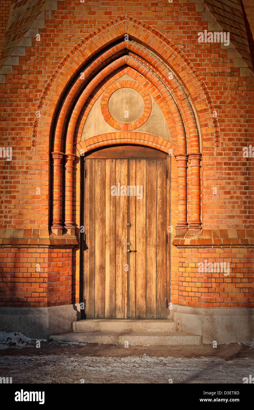 An arched doorway to a gothic style church Stock Photo - Alamy