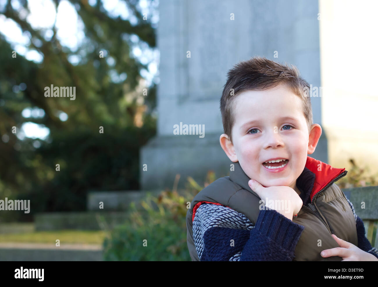 Happy young boy smiling in an outdoor scene Stock Photo - Alamy