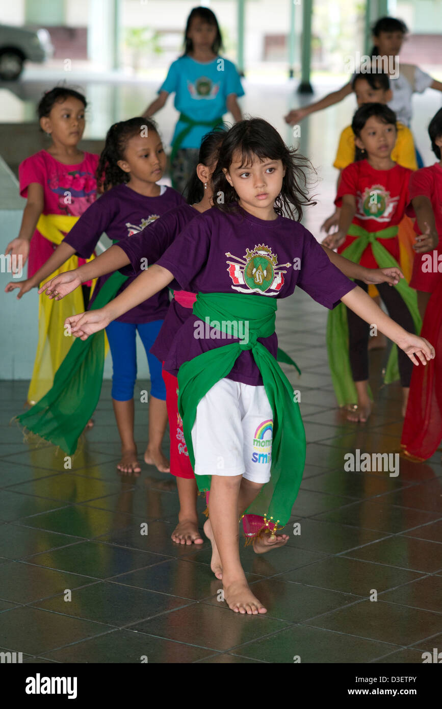 A group of young Javanese dance students practice traditional dance ...