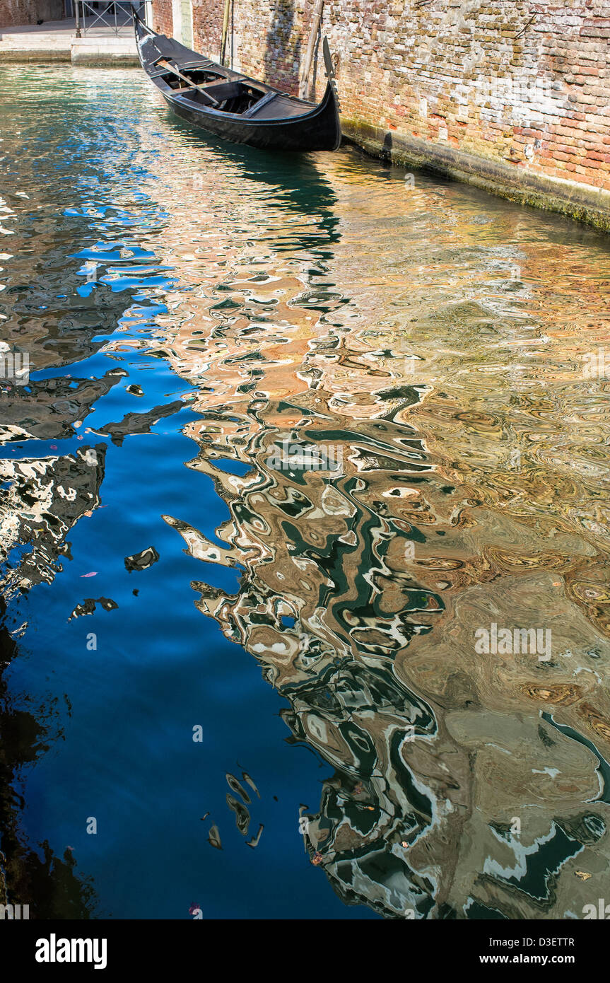 Gondola Moored Beside Building with Reflections on Water in Venice ...