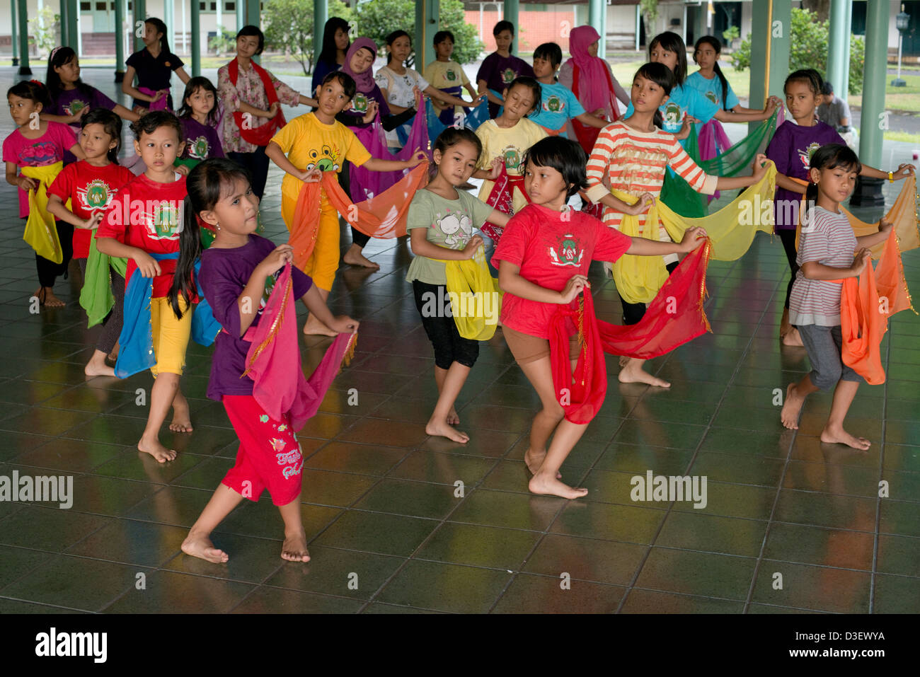 A group of young Javanese dance students practice traditional dance ...