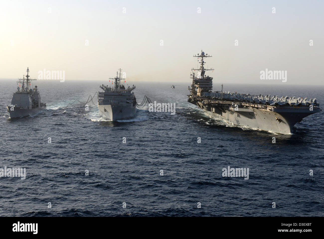Aerial view of the aircraft carrier USS John C. Stennis and guided ...