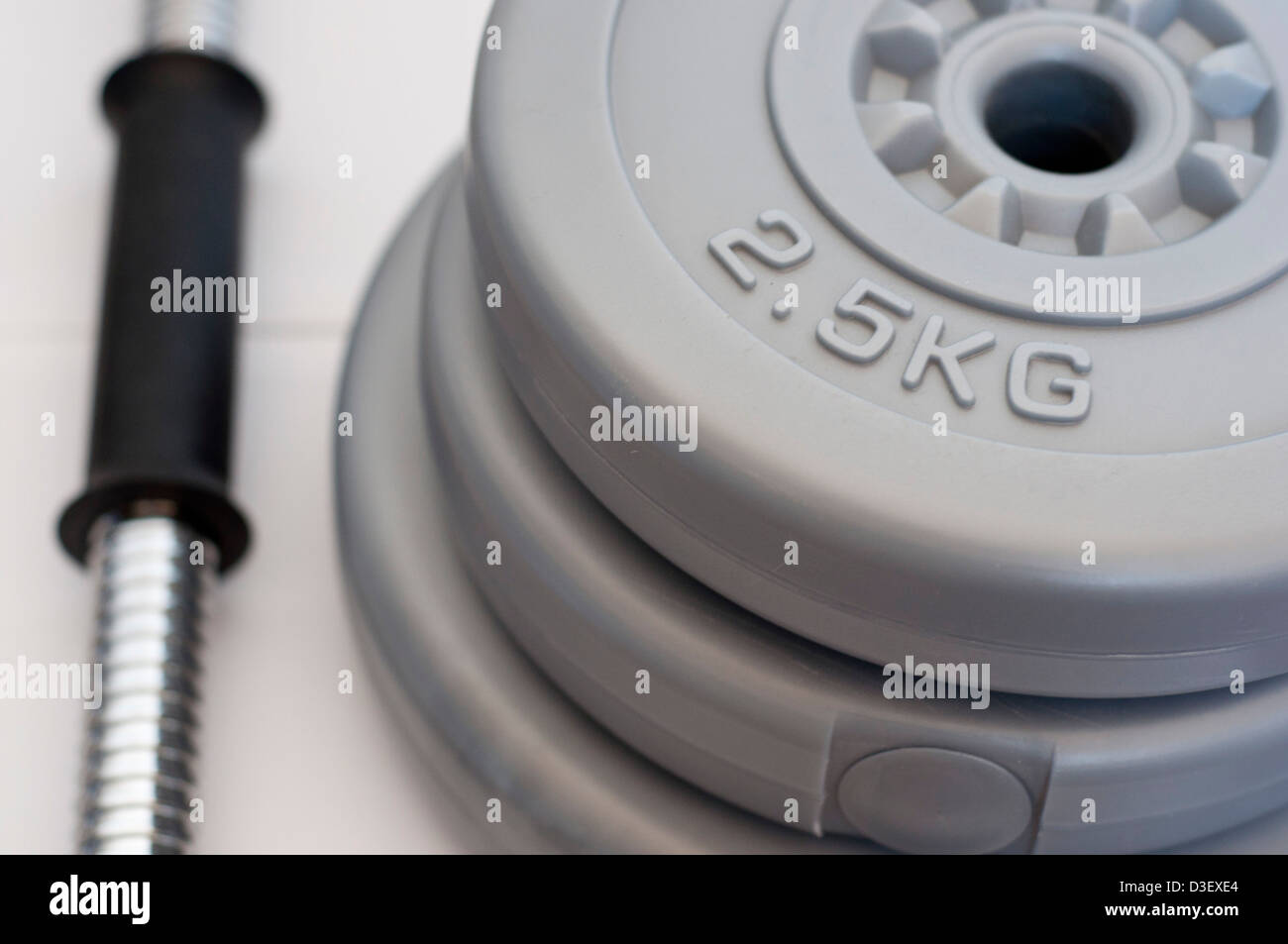 Stack of weights with dumbbell bar Stock Photo - Alamy