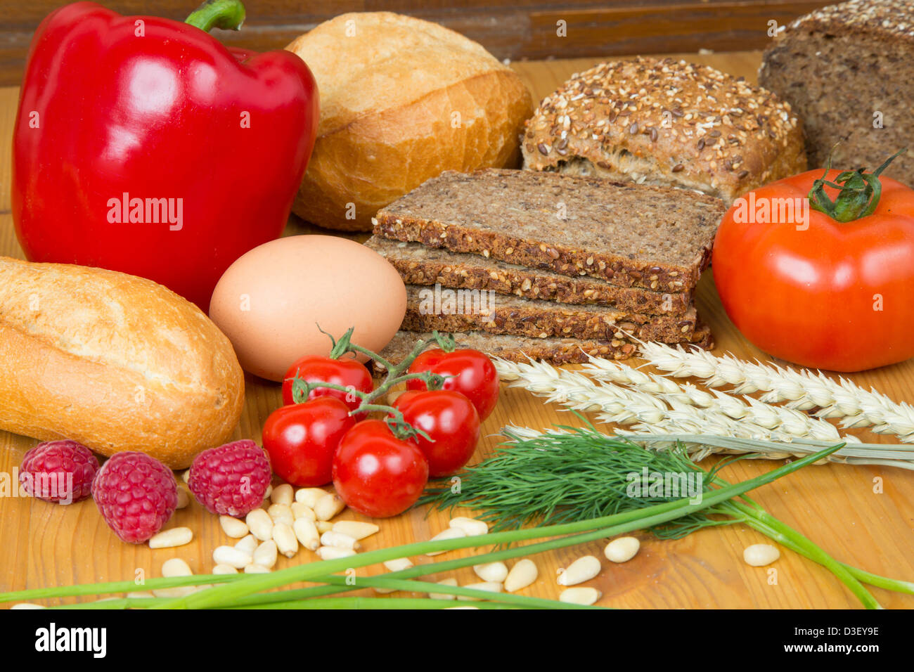 Different types of food such as bread, a tomato, apple, pine seeds ...