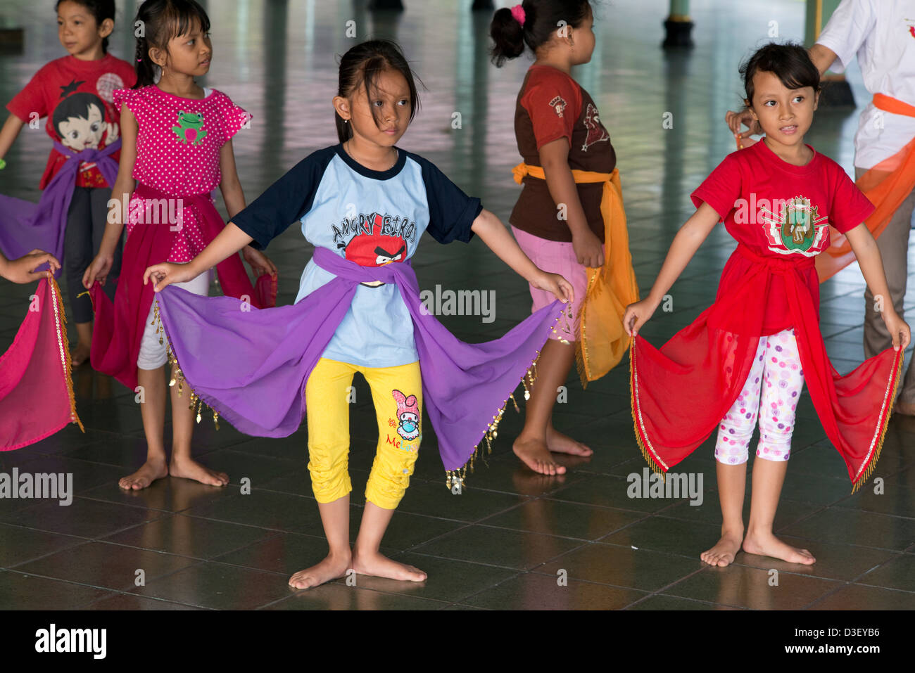A group of young Javanese dance students practice traditional dance ...
