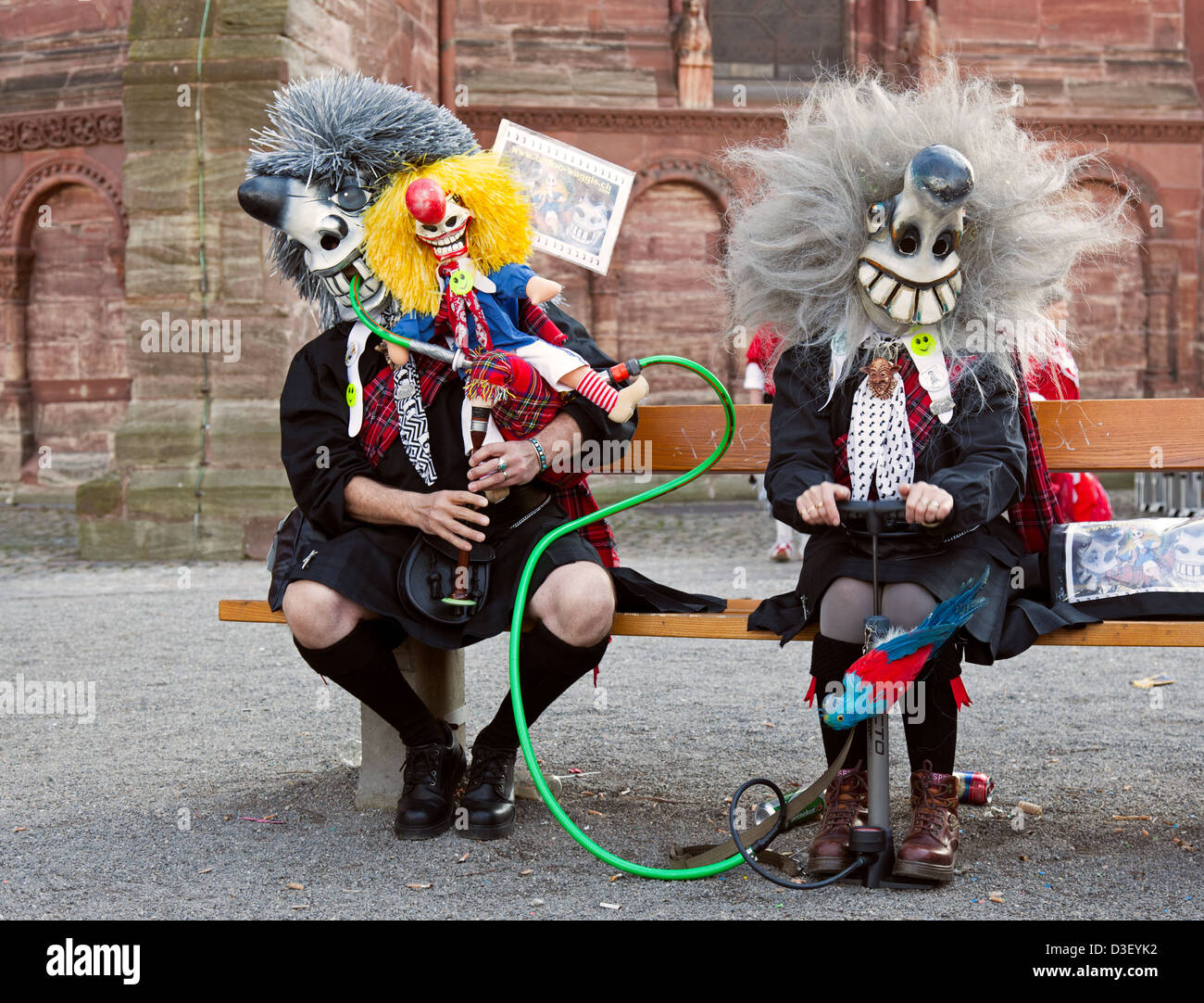 Two crazy costumed Waggis playing music with a bycicle pump on the ...