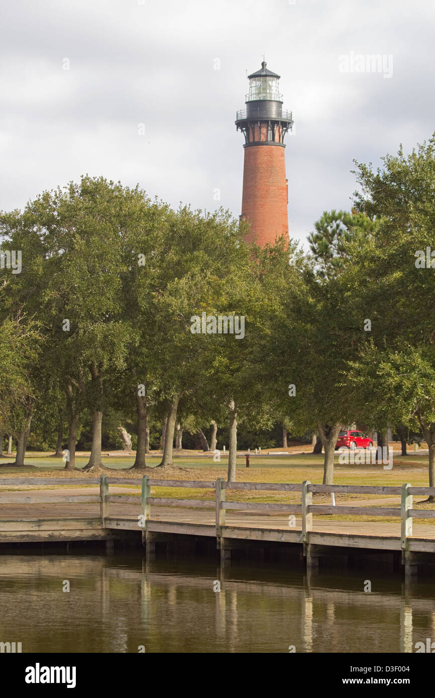 The Currituck Beach Lighthouse and pine trees near Corolla, North ...