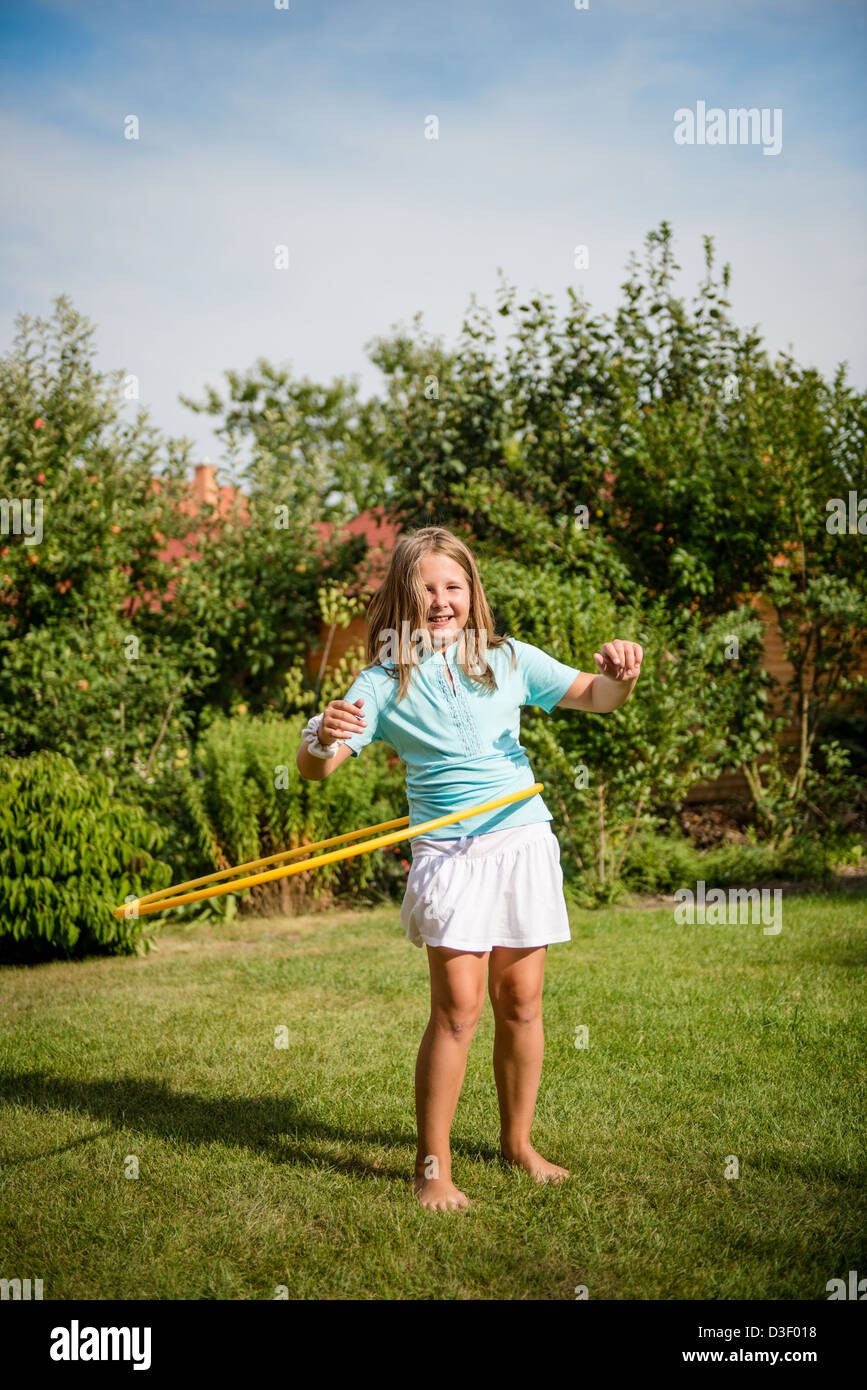 Active child - girl dancing with hoop outdoor in sunny backyard Stock ...