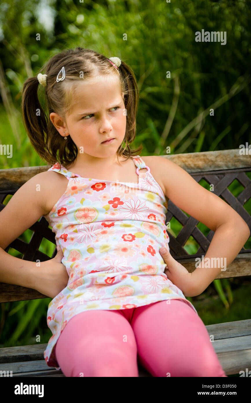 Portrait of small offended girl - outside in backyard Stock Photo - Alamy