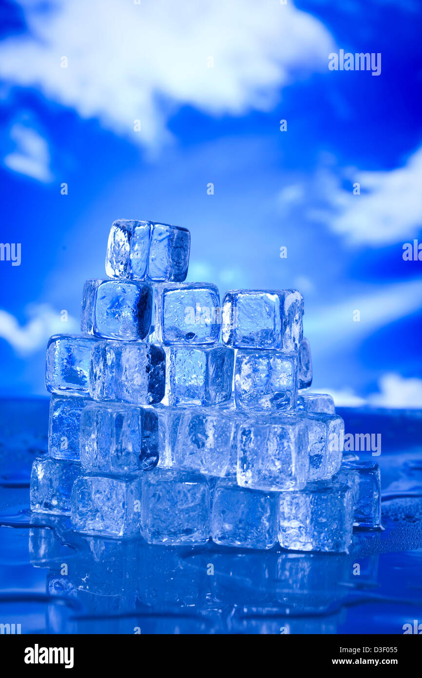 Ice cubes on blue sky background Stock Photo - Alamy