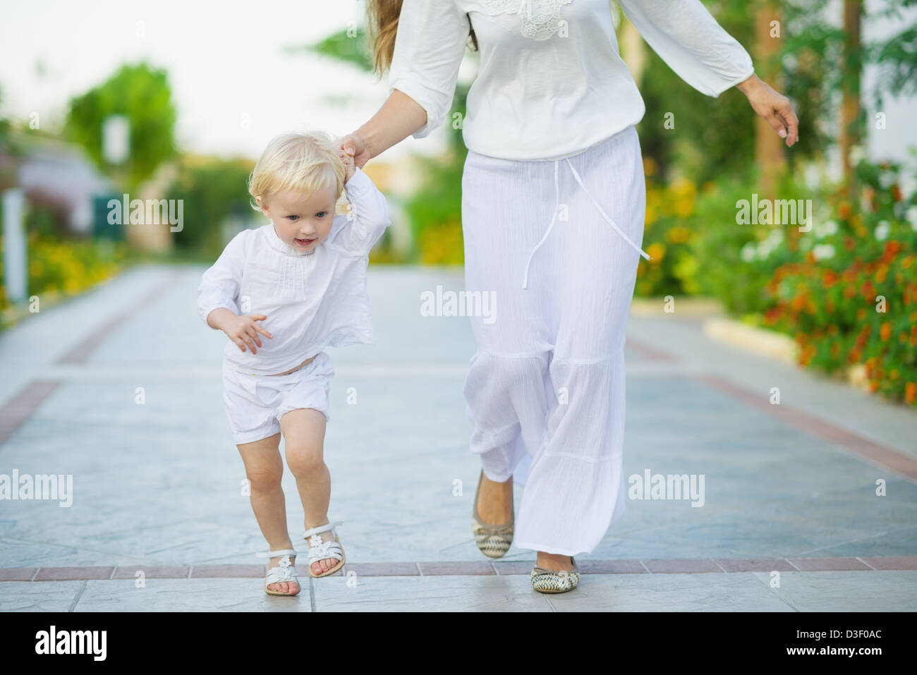 Mother and baby running outdoors Stock Photo - Alamy