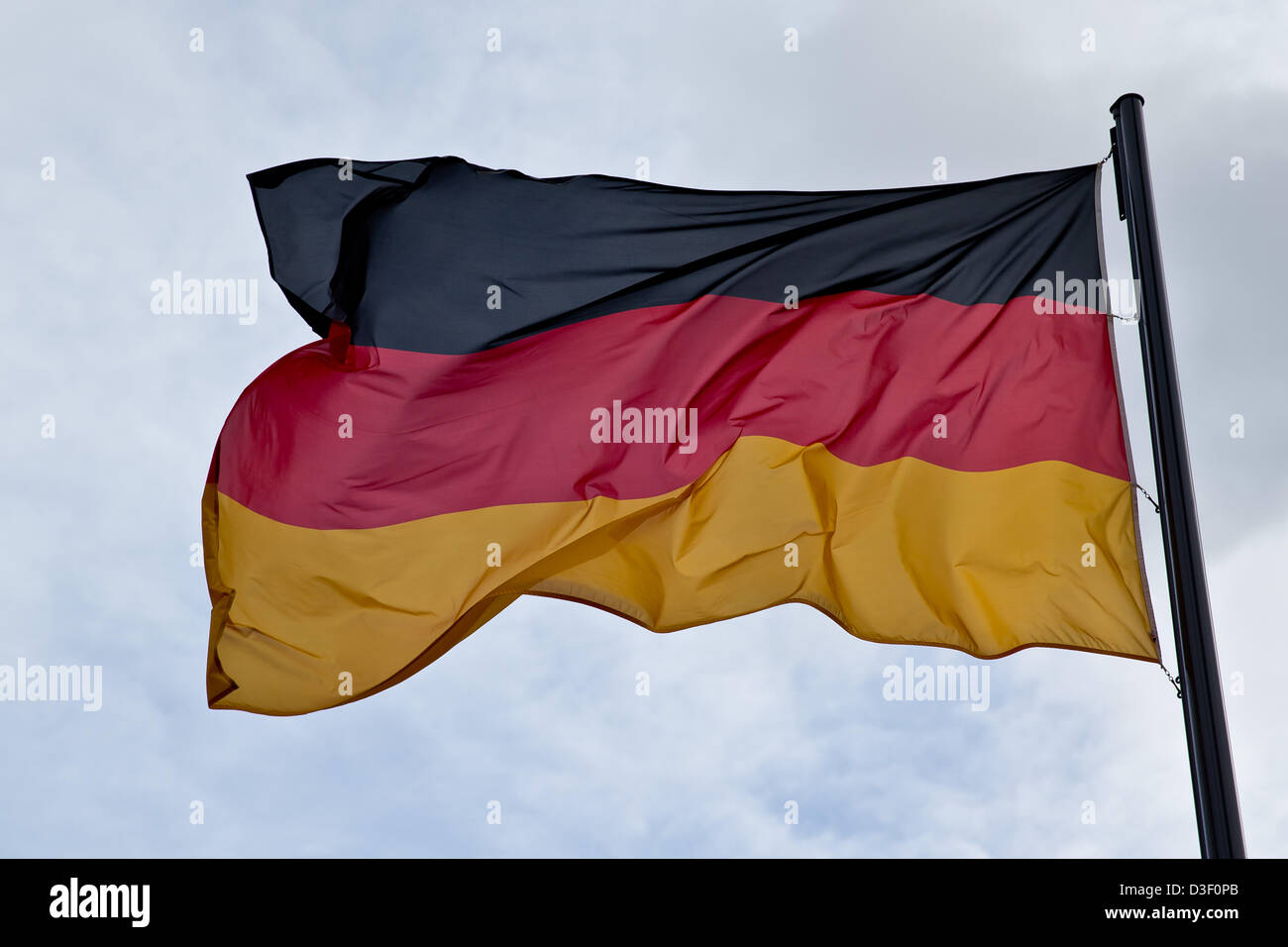 A German ensign shows the national colours of Germany sway in the wind ...