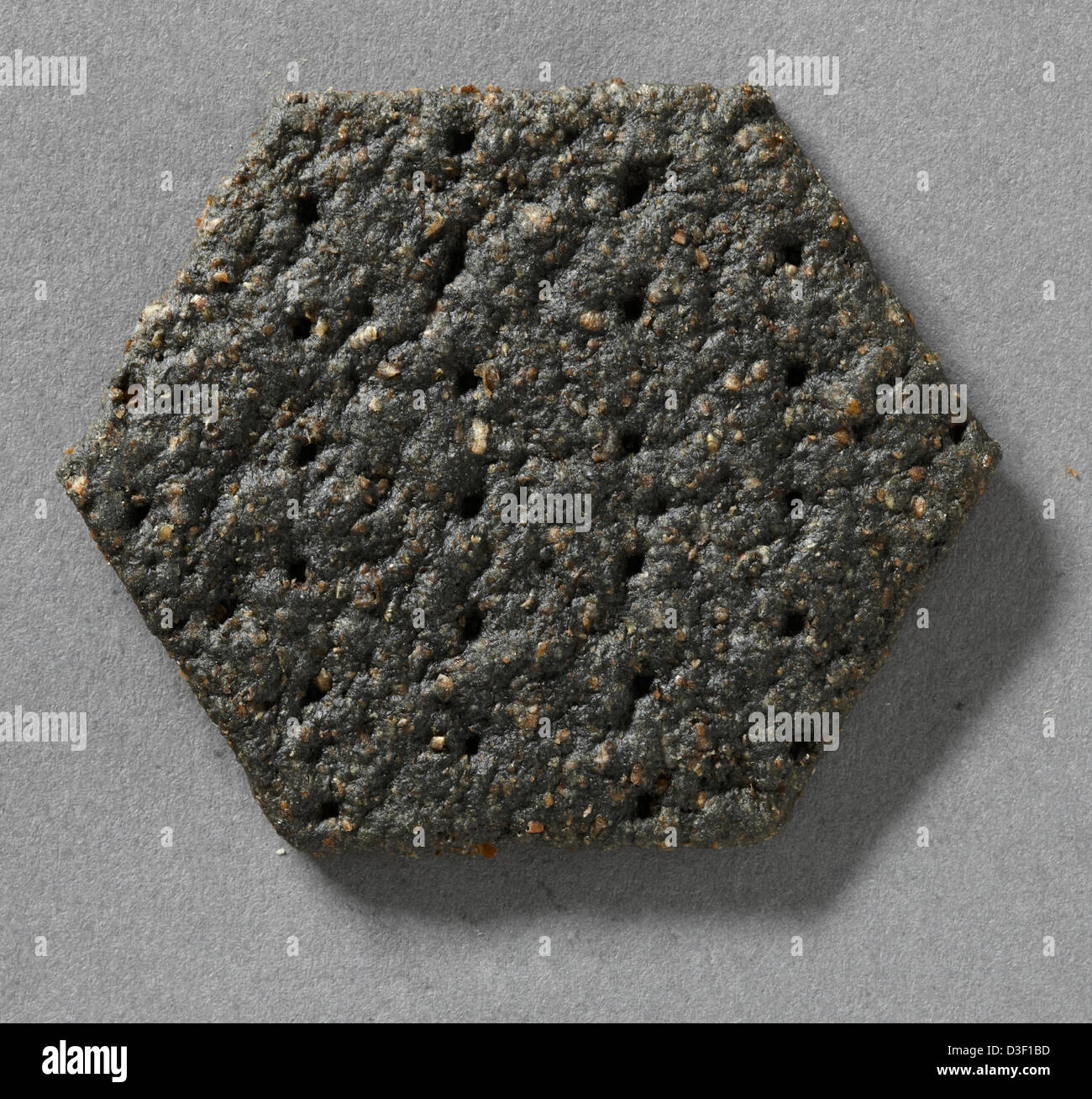 Hexagonal baked savory charcoal biscuit for cheese Stock Photo - Alamy