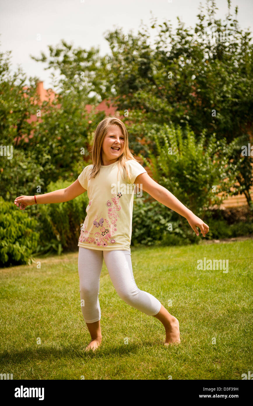 Active childhood - happy child dancing outdoor in backyard Stock Photo ...