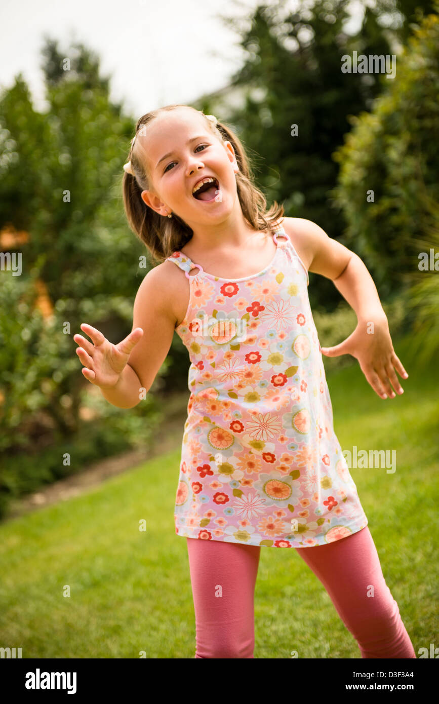 Active childhood - happy child dancing outdoor in backyard Stock Photo ...
