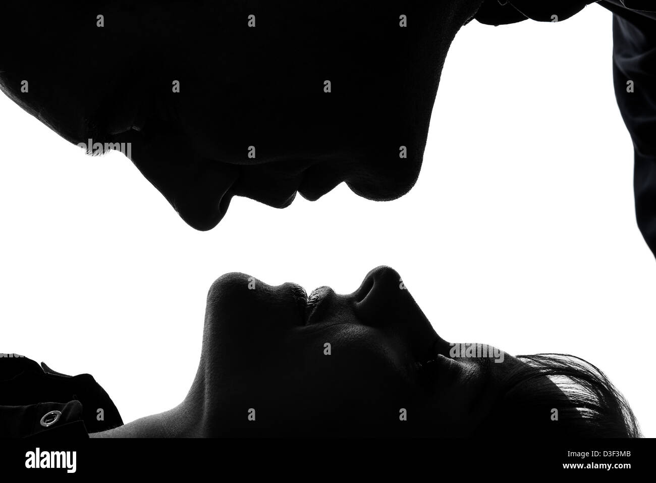 one couple woman man face to face in silhouette studio isolated on ...