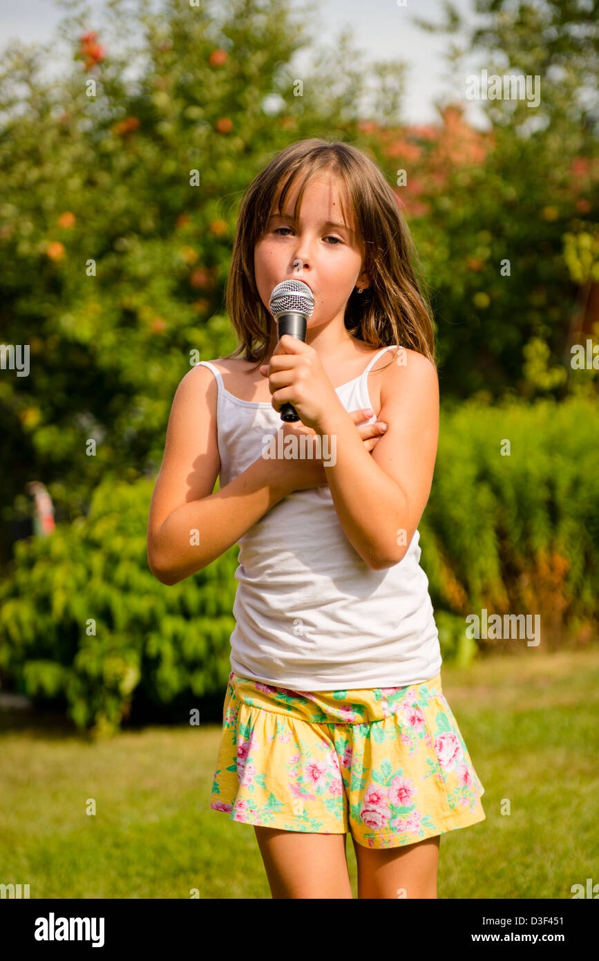 Child singing outside microphone hi-res stock photography and images ...