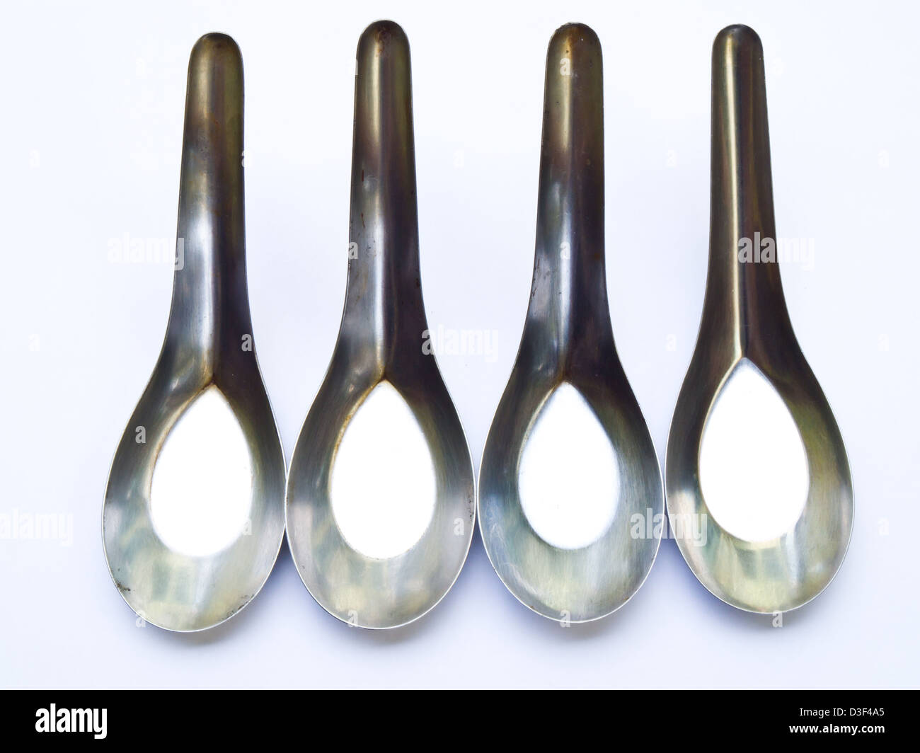 Used stainless steel spoons isolated on white background Stock Photo ...