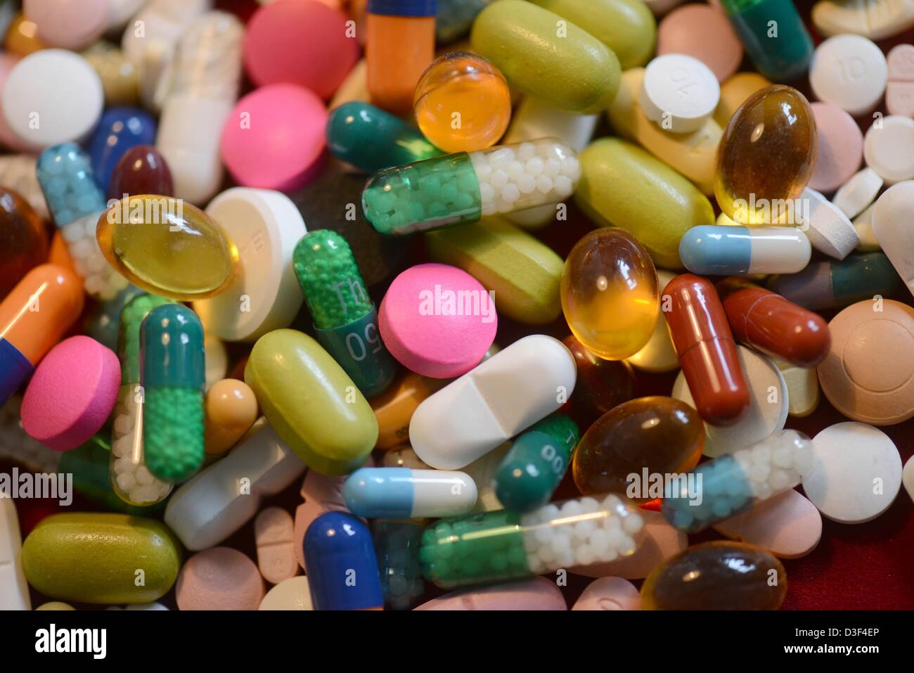 The illustraion show a pile of pills and tablets on display on a table ...